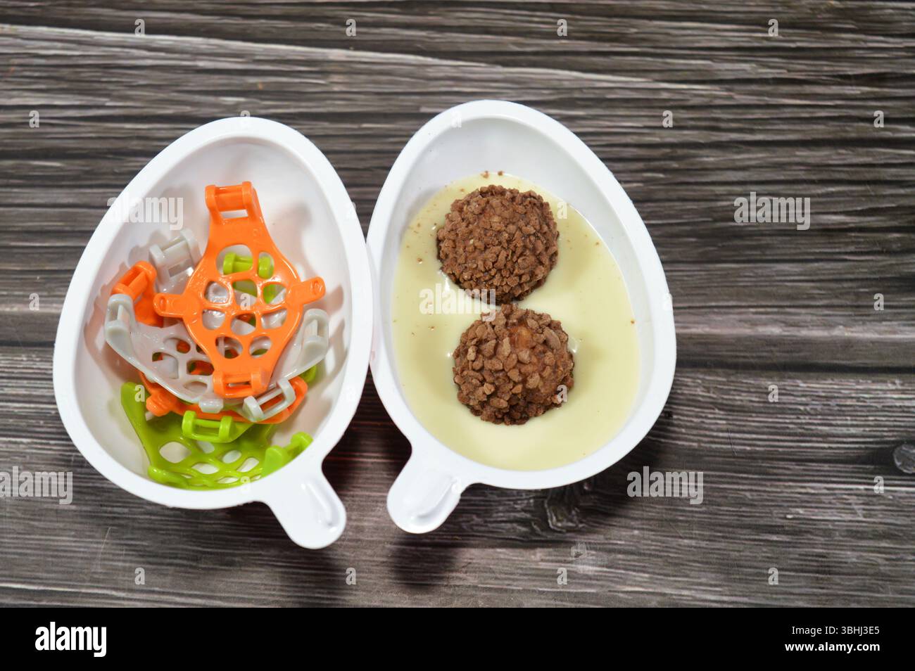 a candy in an egg-shaped plastic packaging that splits into two halves ...