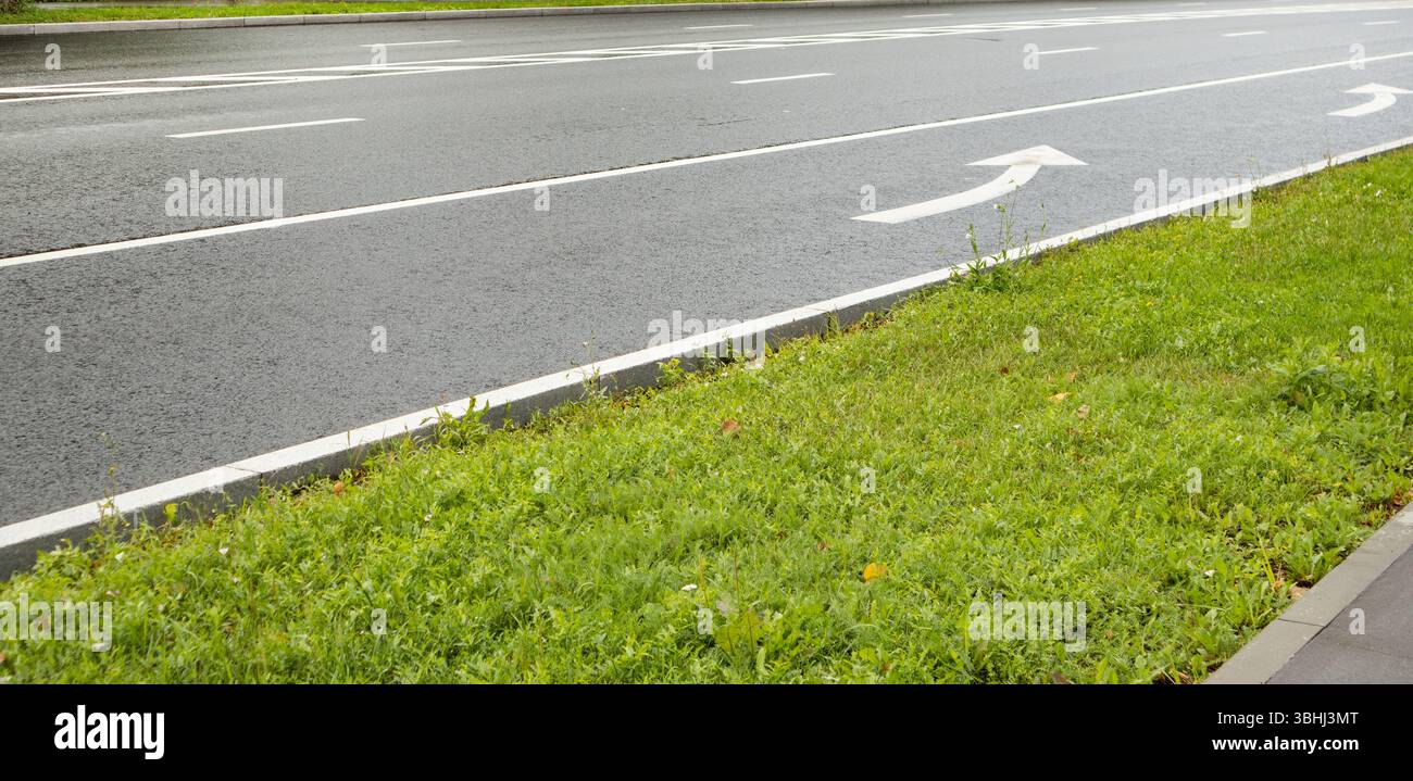 Asphalt roadway with an arrow pointing to the end of the lane pointing ...