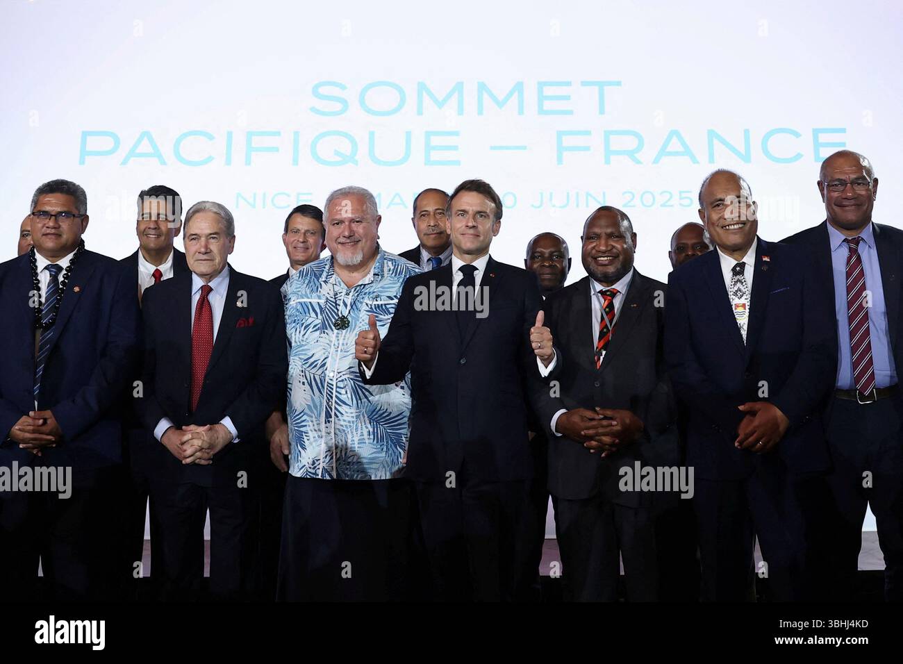 French President Emmanuel Macron, and Moetai Charles Brotherson, center ...
