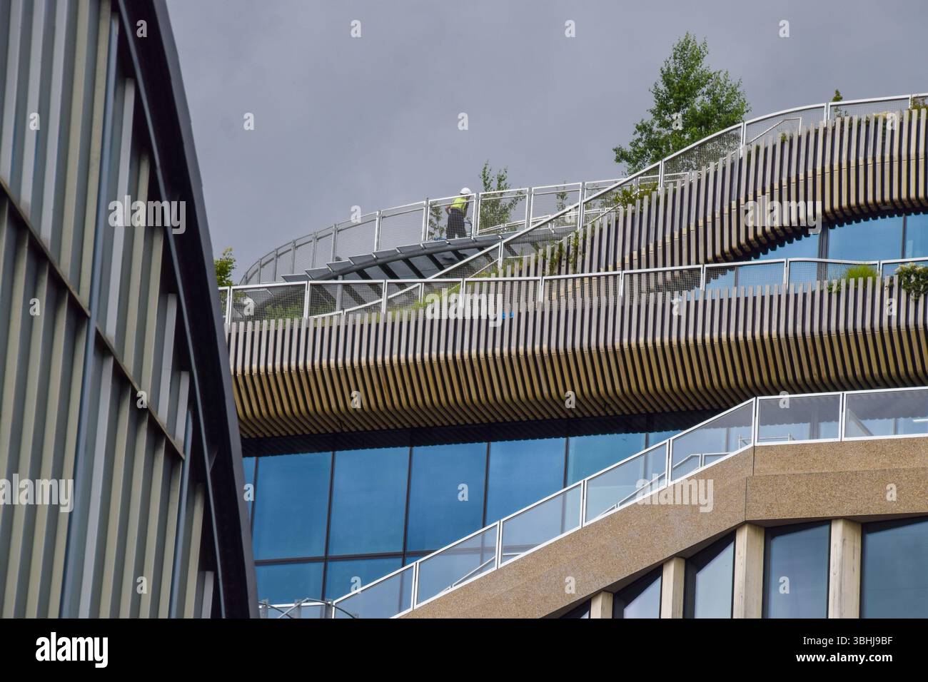 London, UK. 10th June 2025. Workers on the roof of the new Google ...