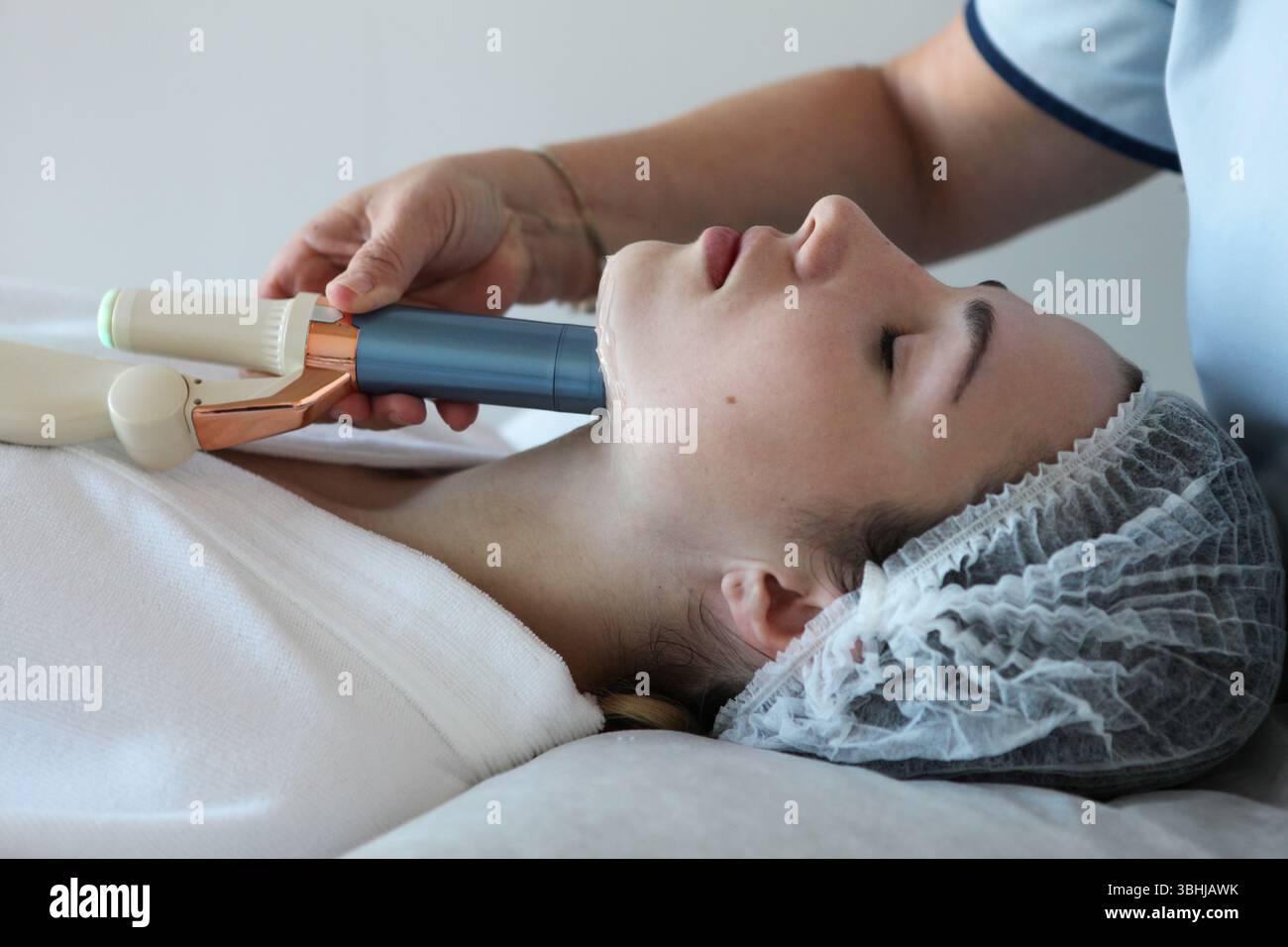 closeup portrait of young woman receives a HIFU (High-Intensity Focused ...