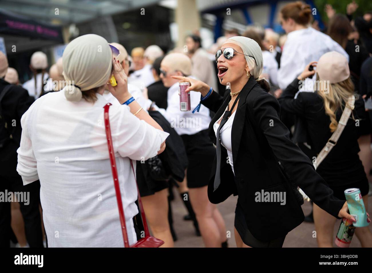 Fans dance in front of the O2 Arena prior to a performance by Pitbull ...