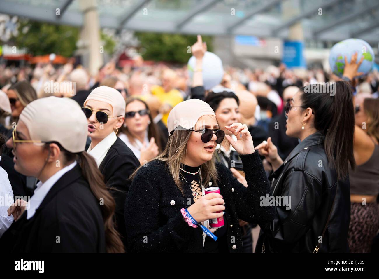 Fans dance in front of the O2 Arena prior to a performance by Pitbull ...