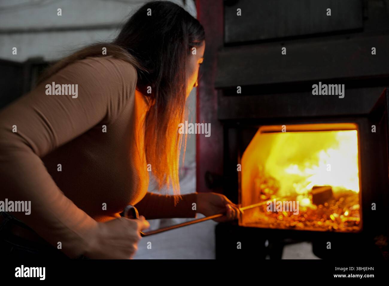 Sustainable Energy Production, a worker Burning Laurel Branches in a ...