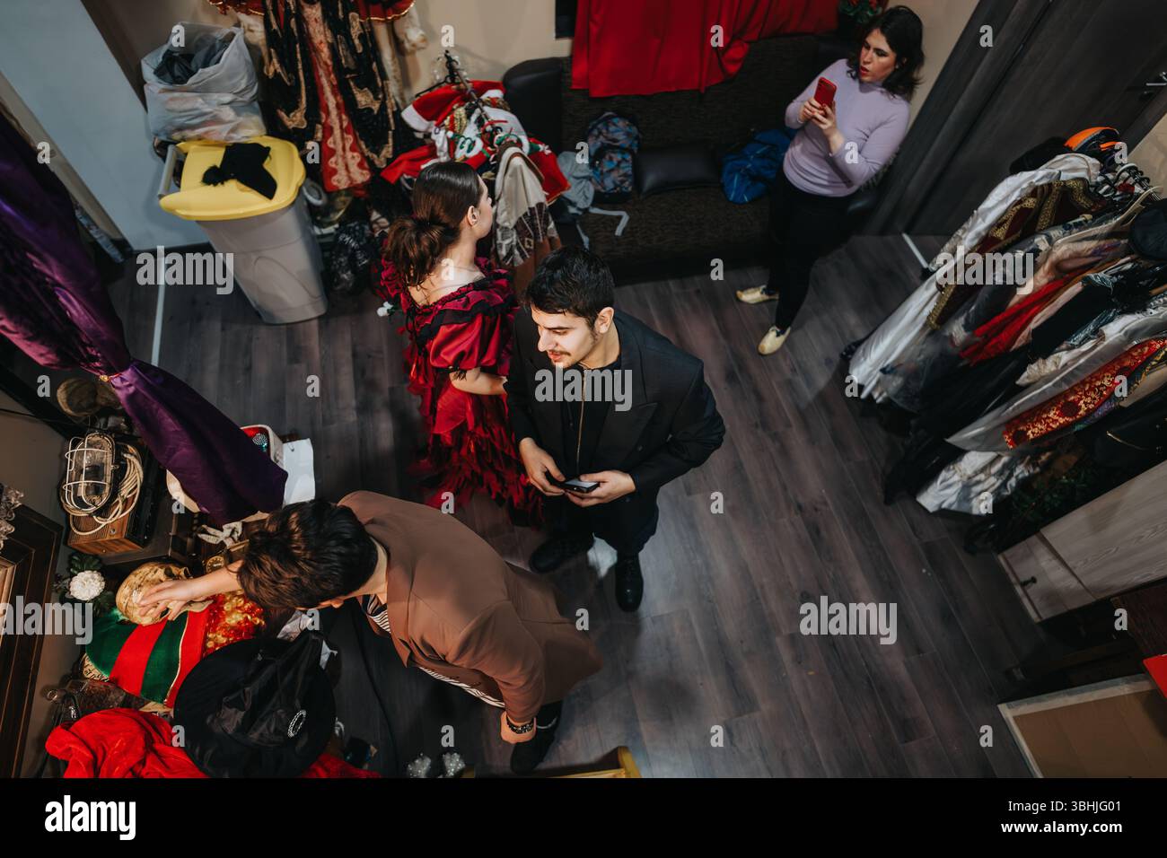 Young actors preparing for a theater performance in a costume-filled ...