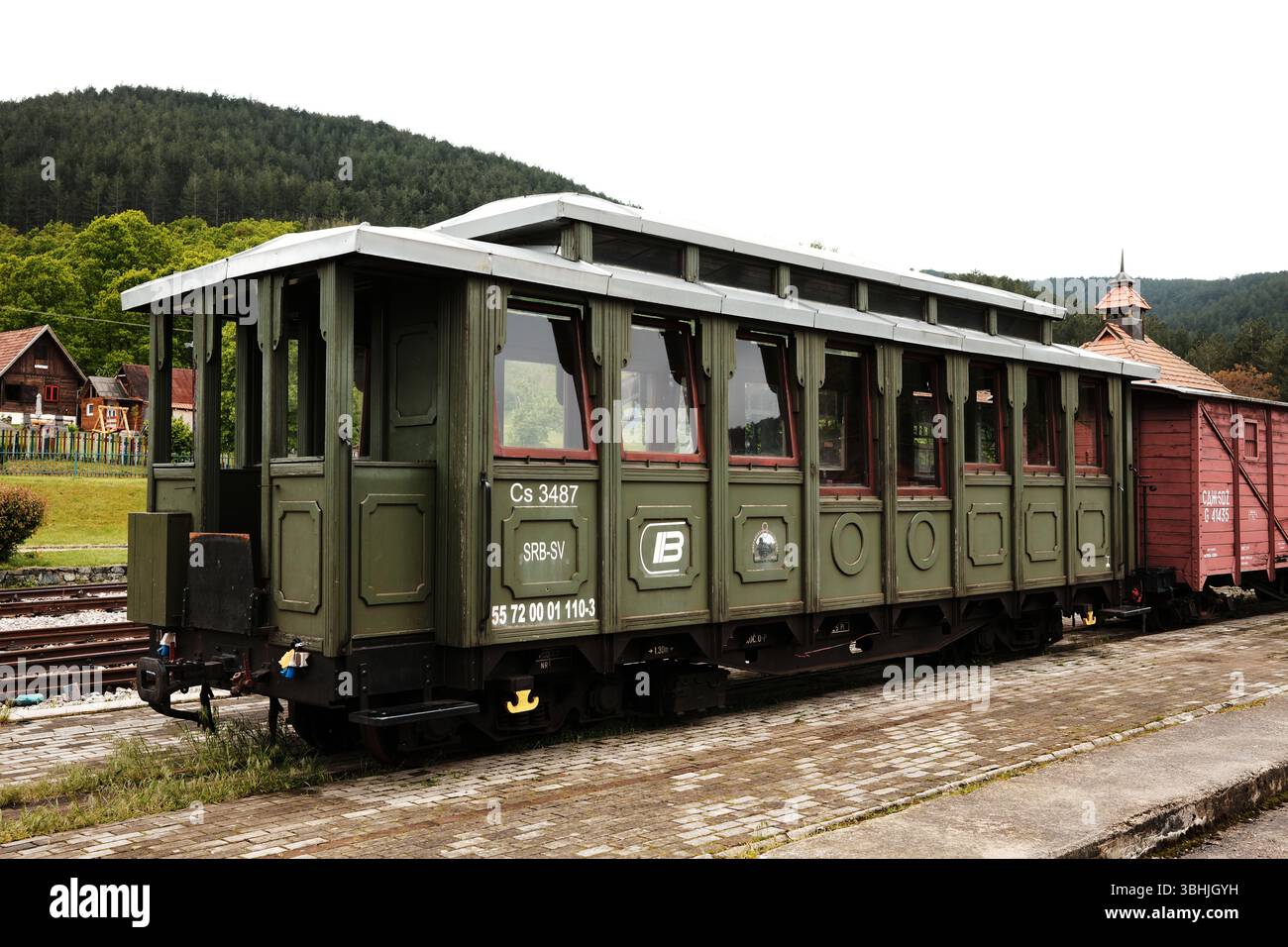 Restored green passenger railcar at train station in spring. Shargan ...
