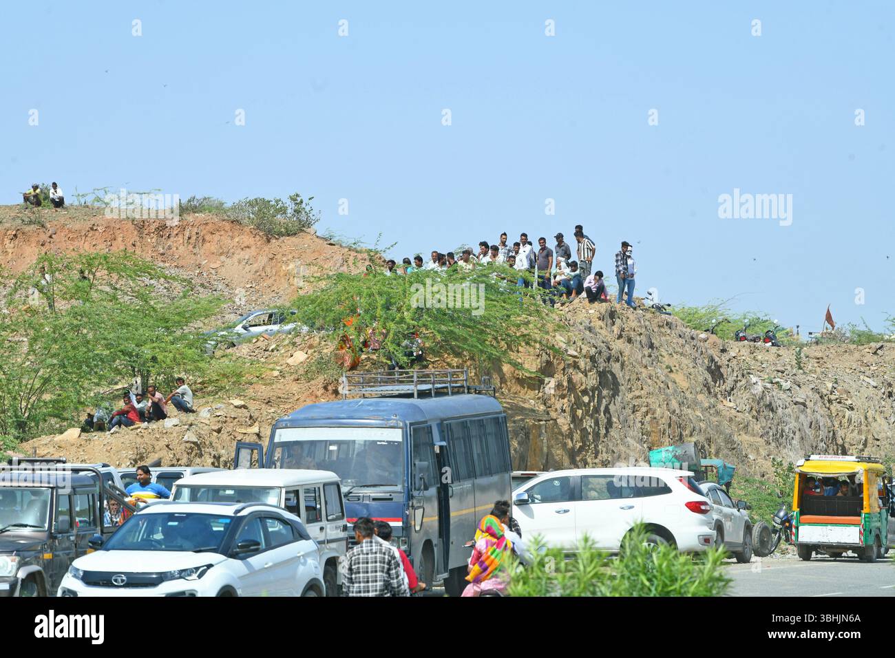Beawar, India, June 9, 2025: Rajasthani people wait on a rock to see ...