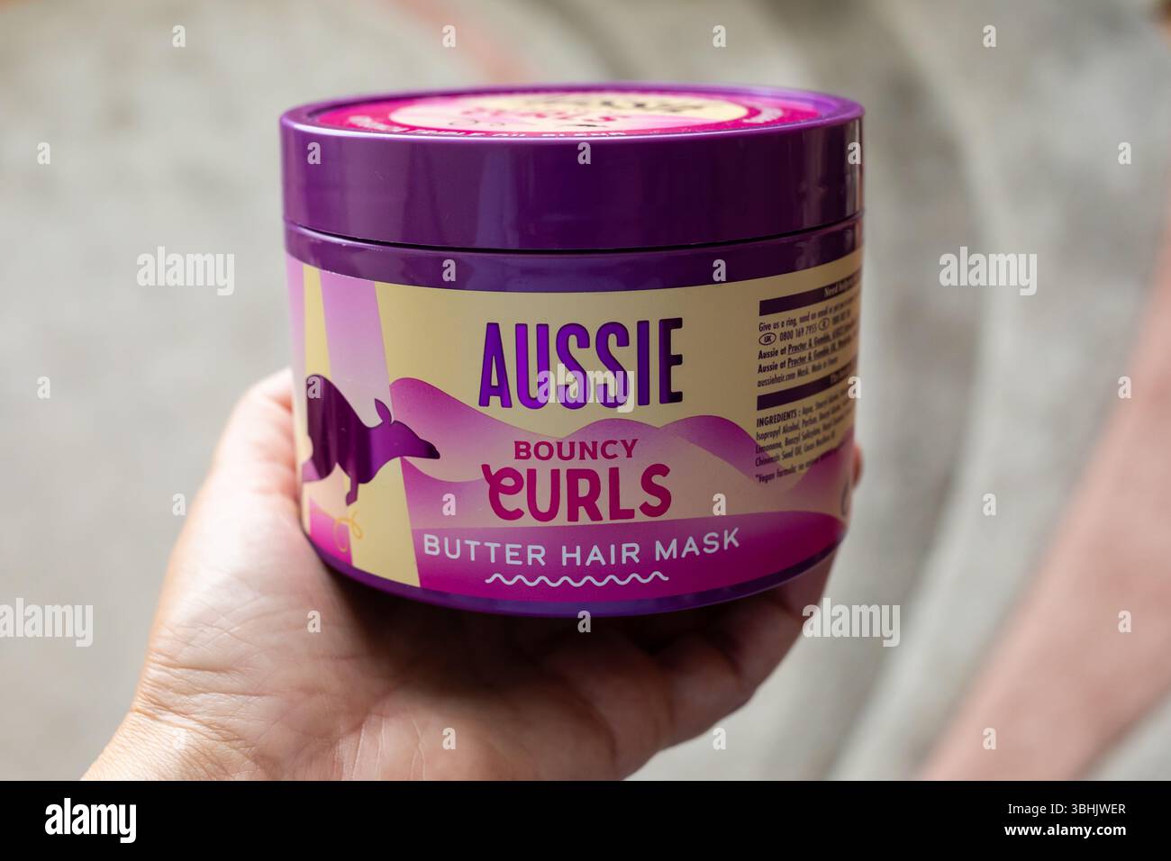 Photograph of a tub of Aussie bouncy curls hair mask Stock Photo - Alamy