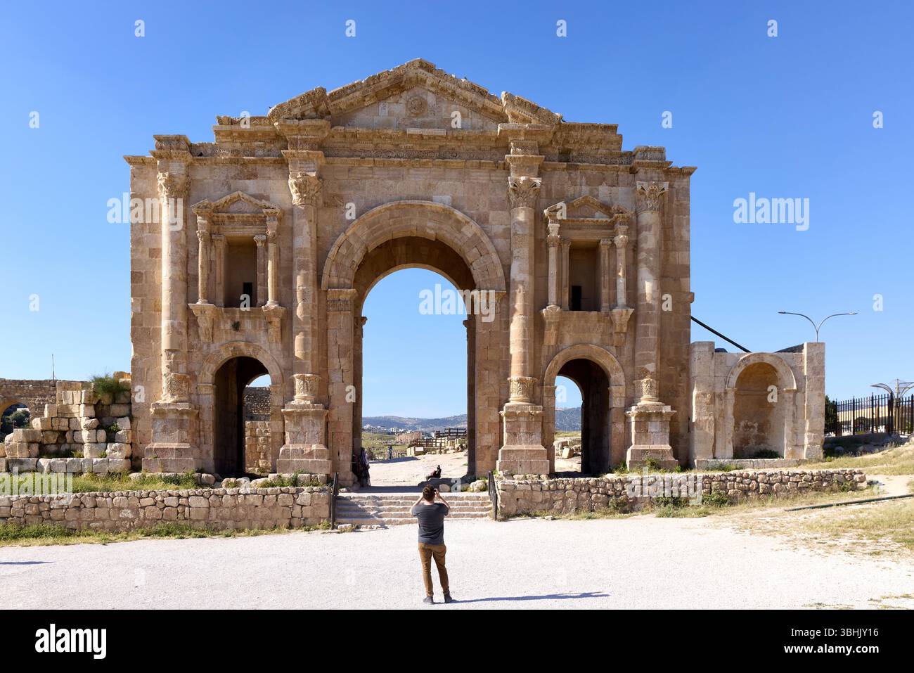 Visitors marvel at the Arch of Hadrian, an impressive Roman structure ...