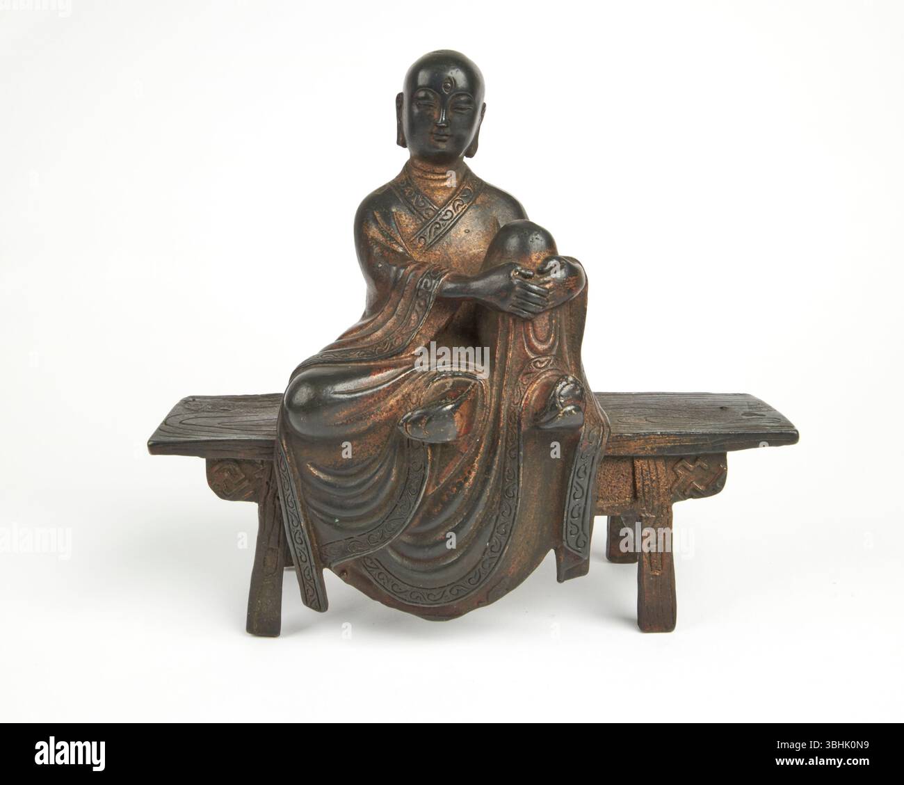 Vintage 20th century chinese bronze figure resting on a bench hi-res ...