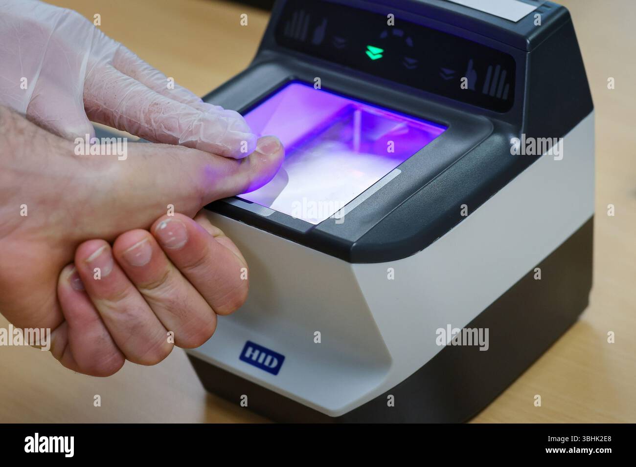 Zirndorf, Germany. 10th June, 2025. An employee takes the fingerprints ...