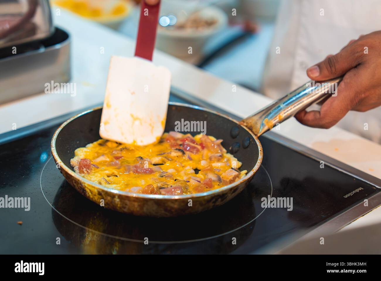 Person using induction stove hi-res stock photography and images - Alamy