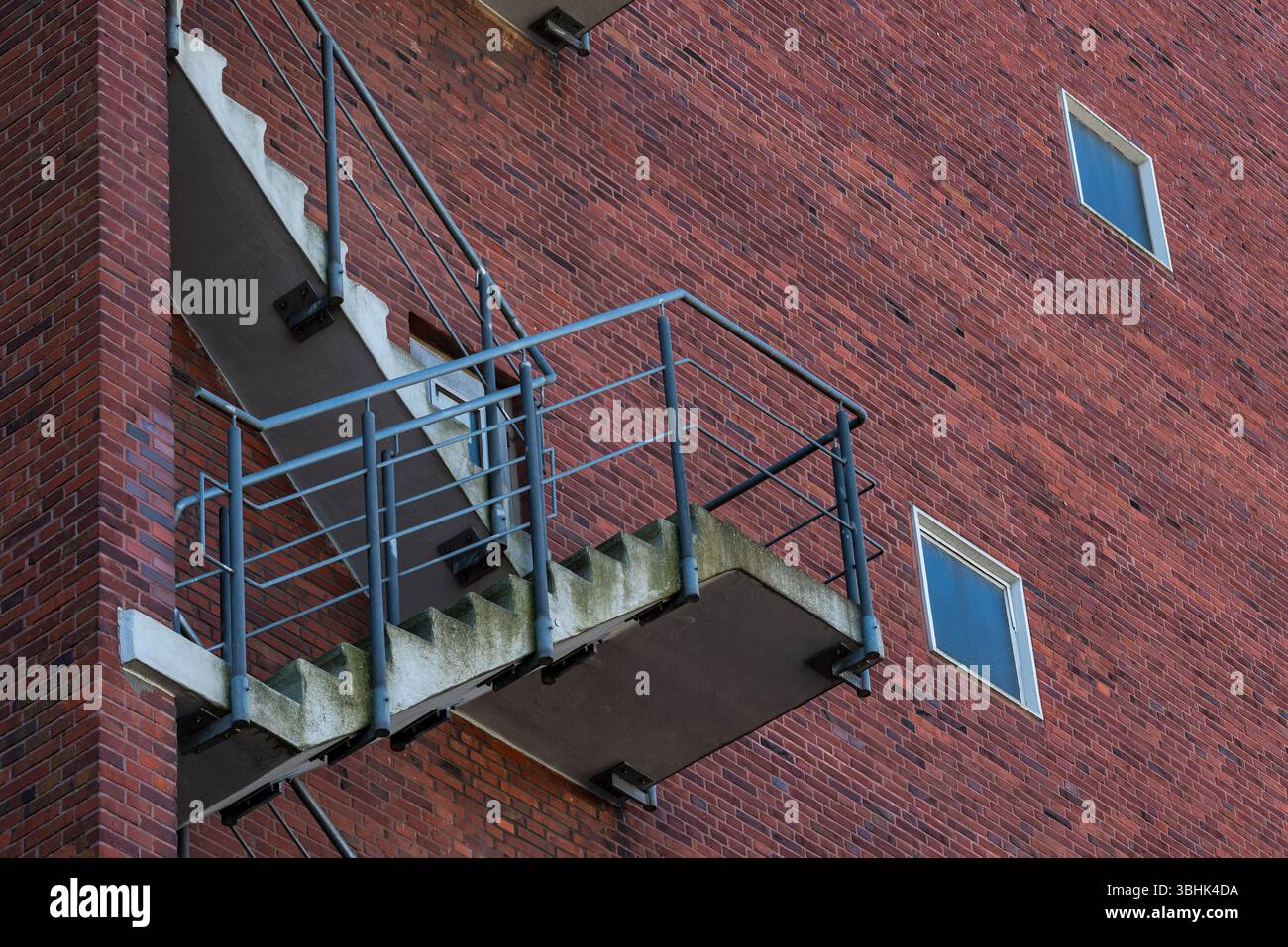 A metal staircase extends from a brick building, showcasing its ...