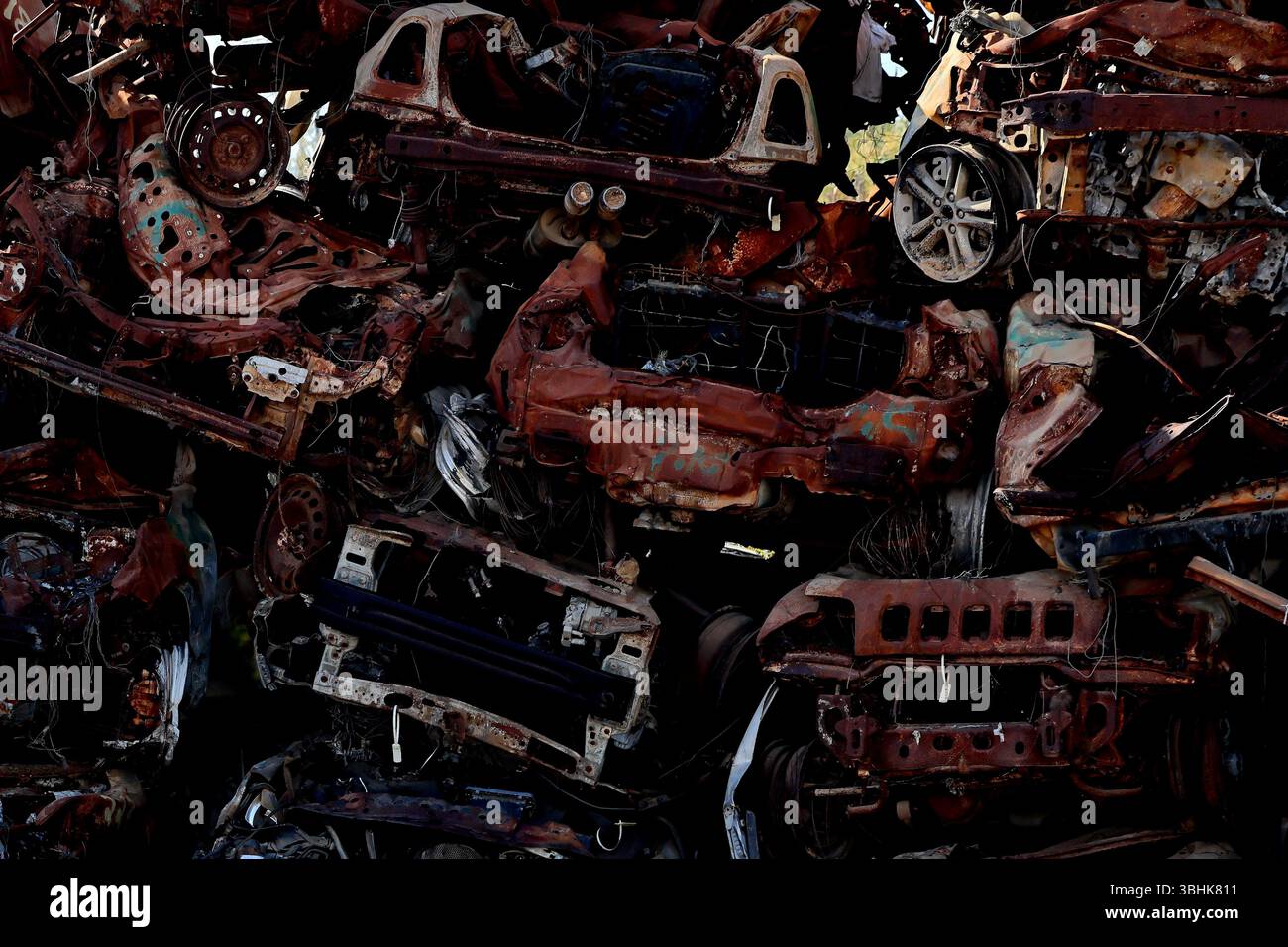 Charred wreckage stacked high at the Car Wall memorial near Tkuma where ...