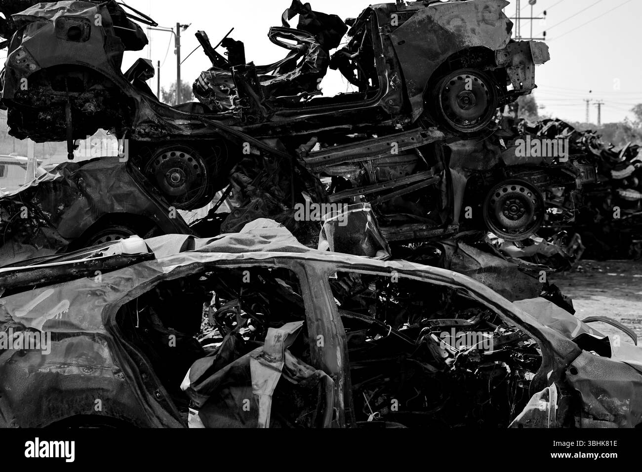 Crushed and stacked vehicles form a grim sculpture of destruction at ...