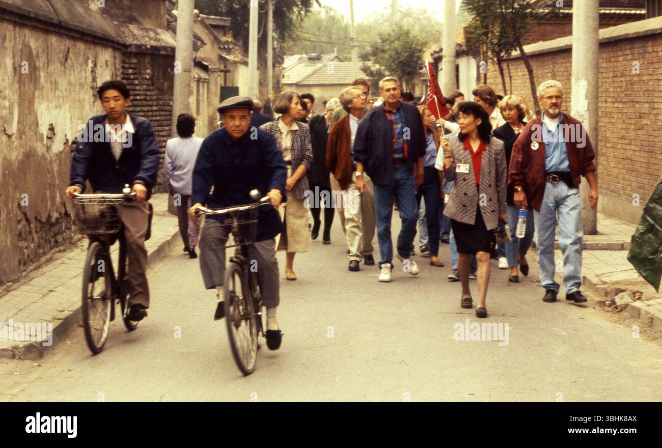 1980s Beijing Hutong Street Scene with Local Cyclists and Foreign Tour ...