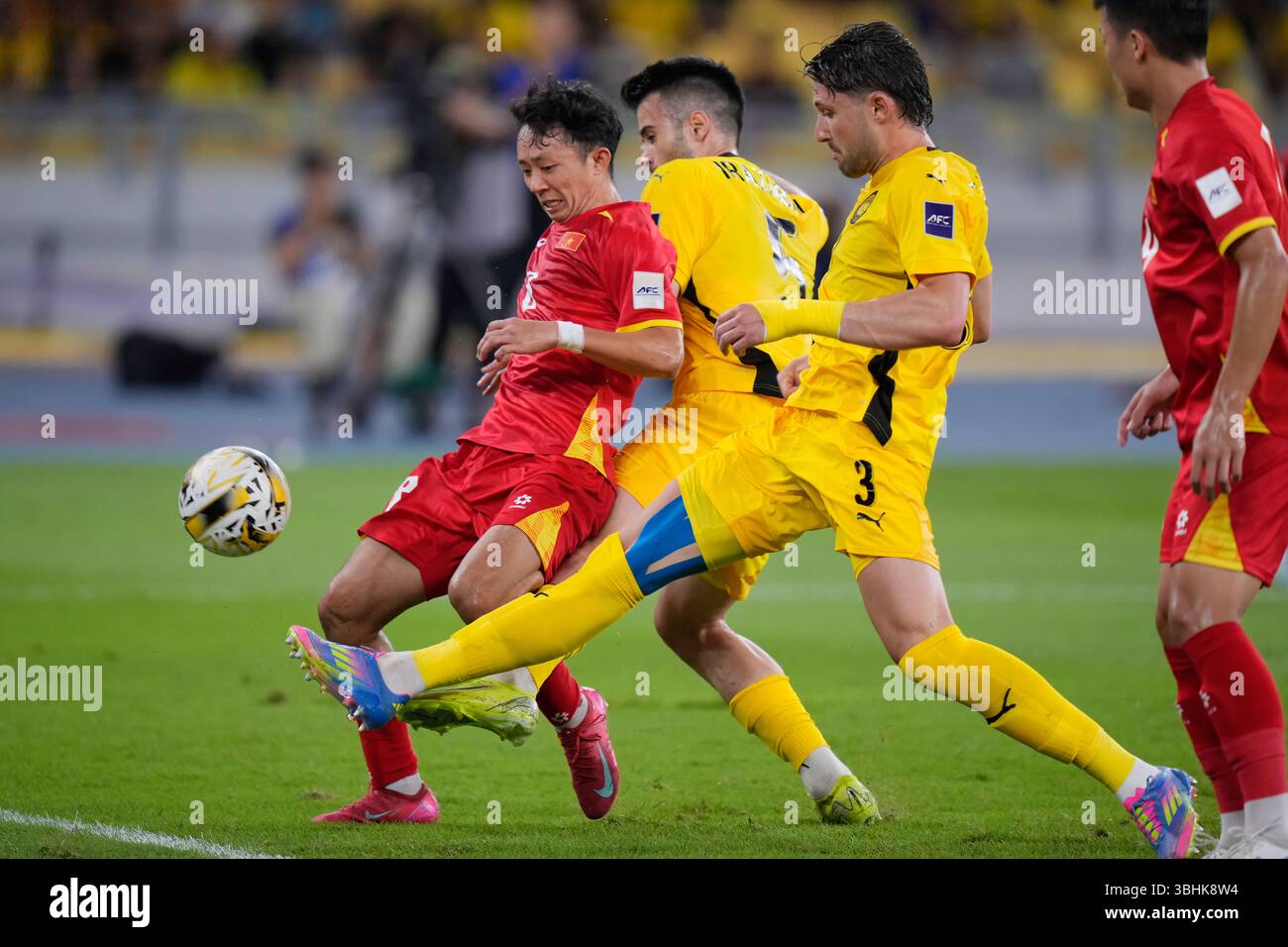 Vietnam's Chau Ngoc Quang, left, fight for control of the ball with ...