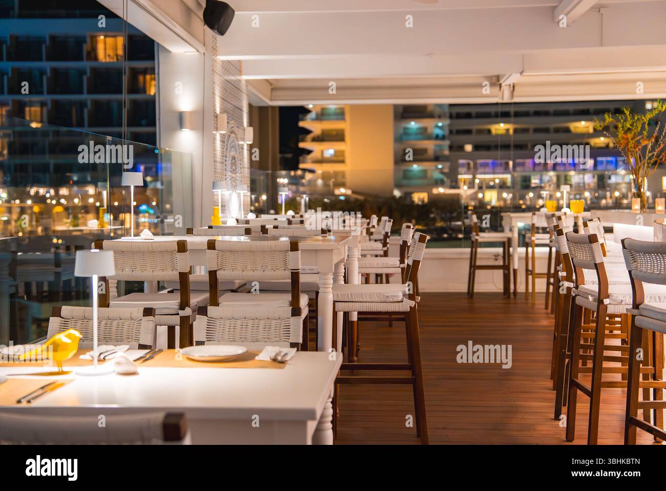 Open Air Restaurant with White Furniture and Modern Hotel Backdrop ...