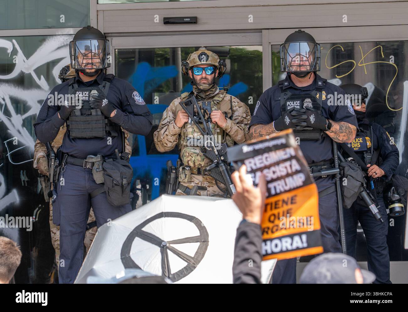 Protesters swarm through downtown Los Angeles with homemade signs and ...
