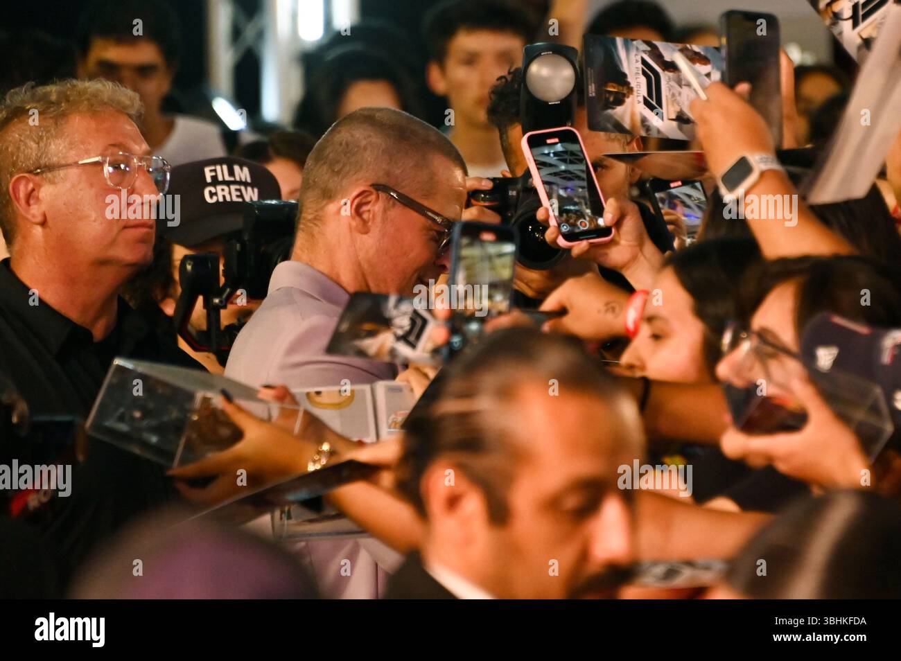 Actor Brad Pitt signs autographs for fans during the black carpet event ...