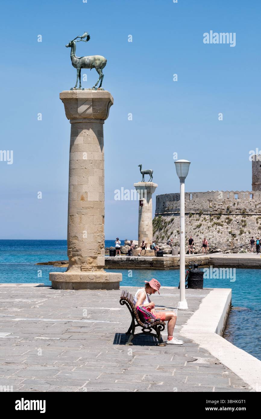 Rhodes, Greece. The entrance to Mandhraki Harbour in the medieval old ...
