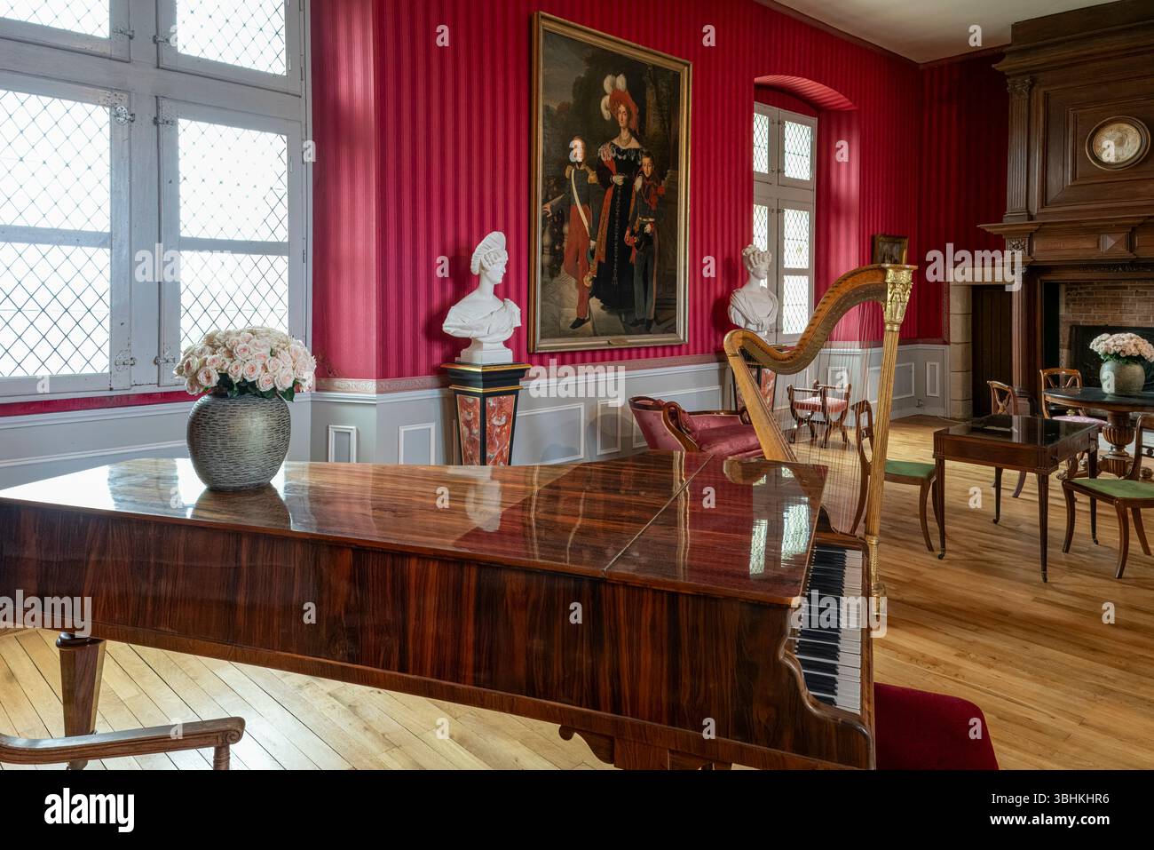 Elegant red salon features period furniture, portraits and decorative ...