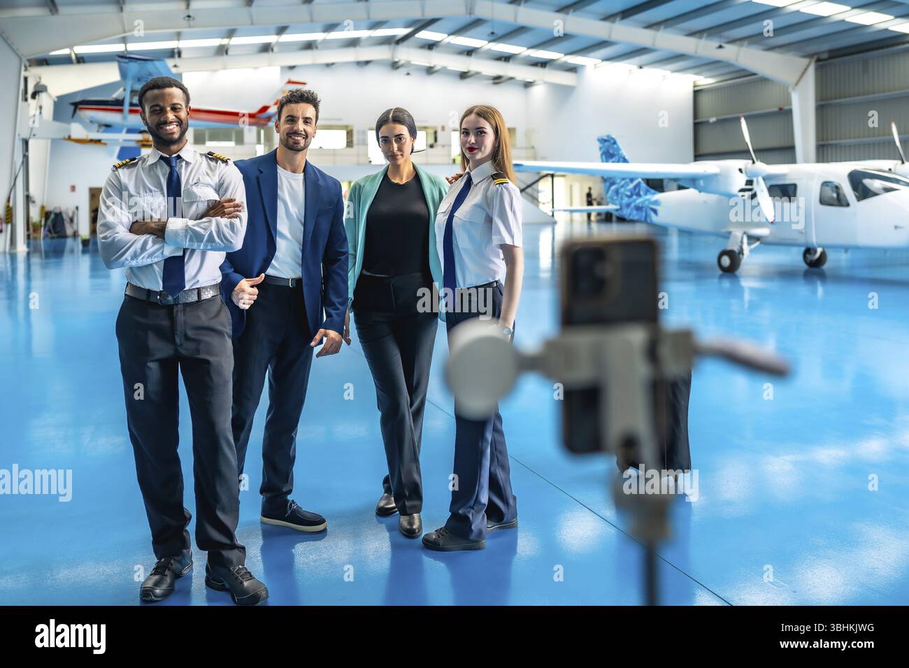 Pilots and a manager recording a video on a smartphone mounted on a ...