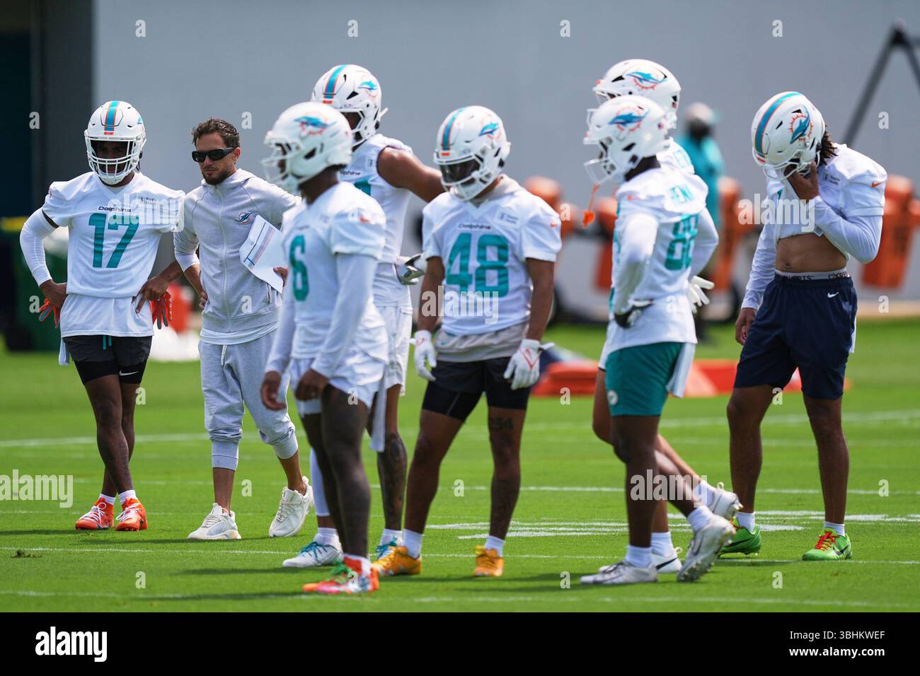 Miami Dolphins head coach Mike McDaniel, second left, stands with ...