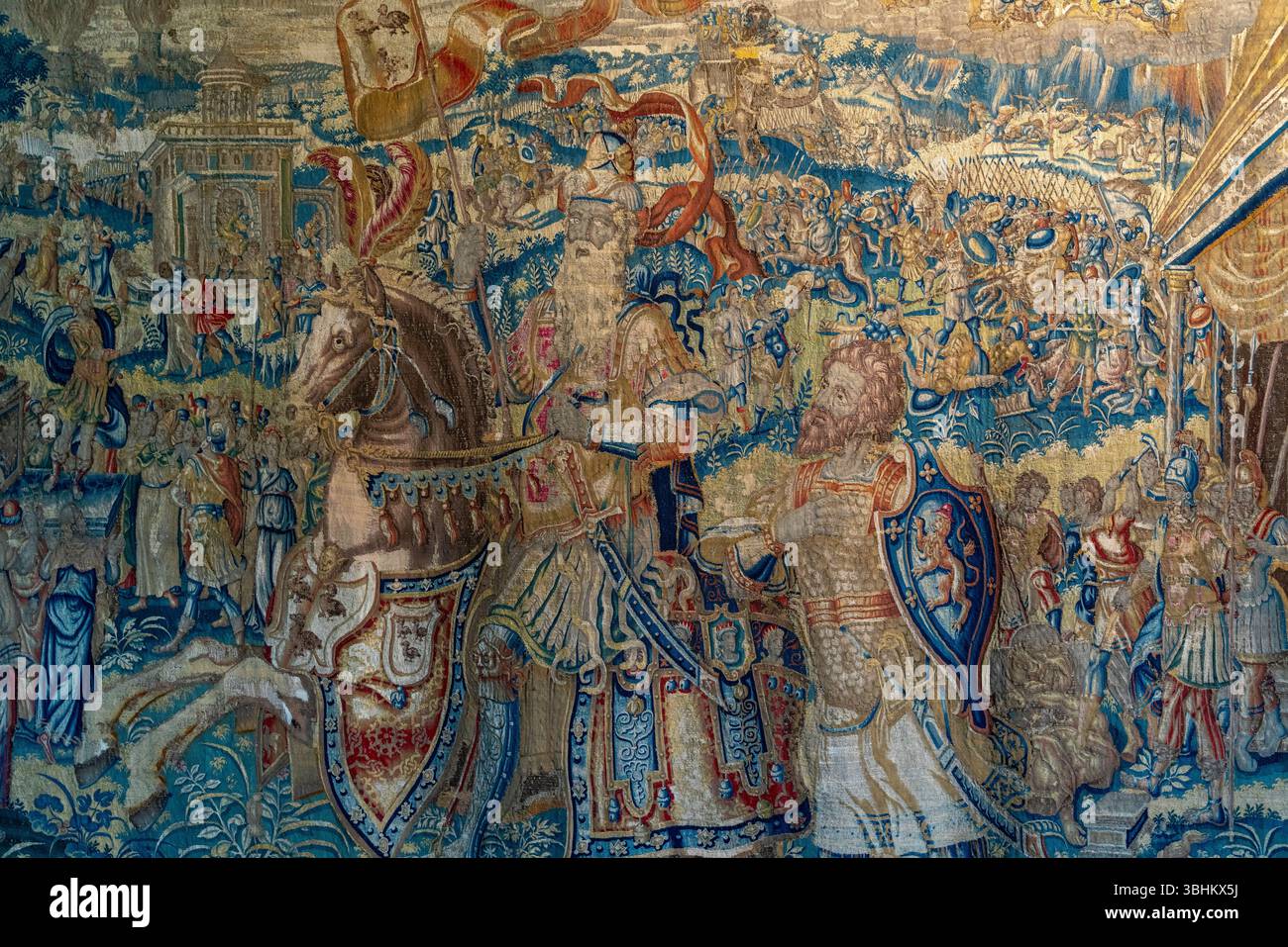 Historical tapestry with intricate medieval scenes depicting battles ...