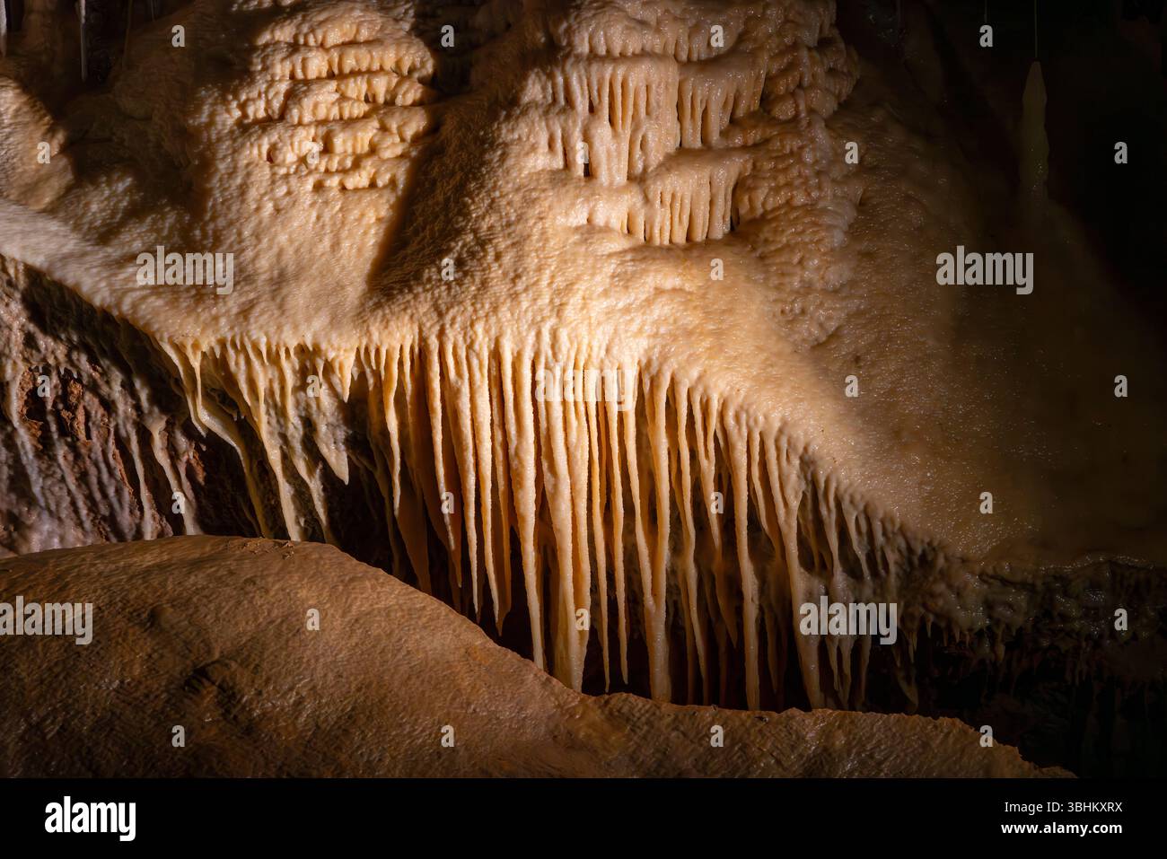 Impressive limestone formations and flowstone cascades with golden ...