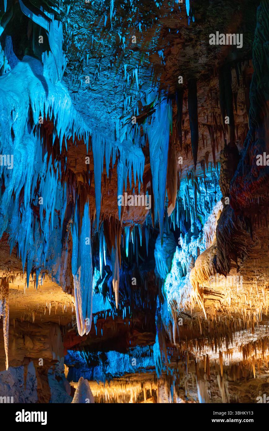 Spectacular blue illuminated stalactites and stalagmites creating ...