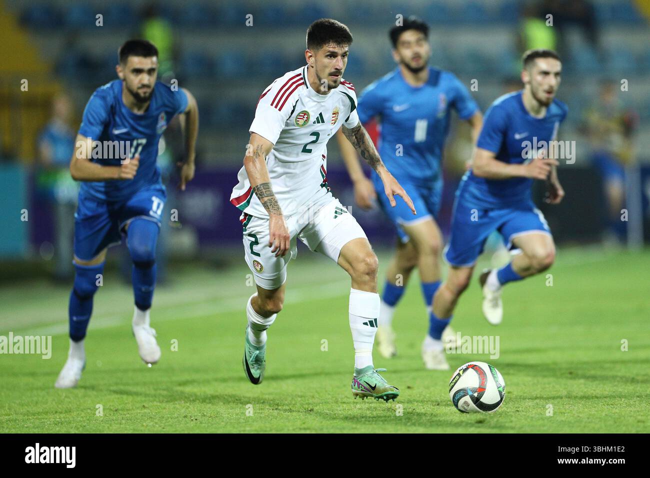 Hungary's Attila Osvath, centre, leads the ball during an international ...