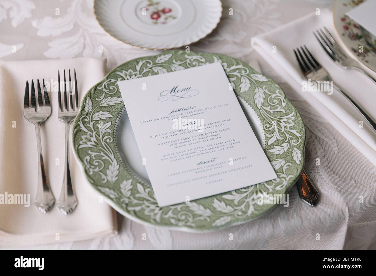 An elegantly arranged table displays a decorative plate and a ...