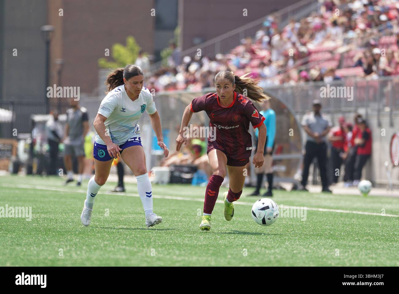 Colby Barnett #31 of AFC Toronto is pressured by Melanie Forbes #21 of ...