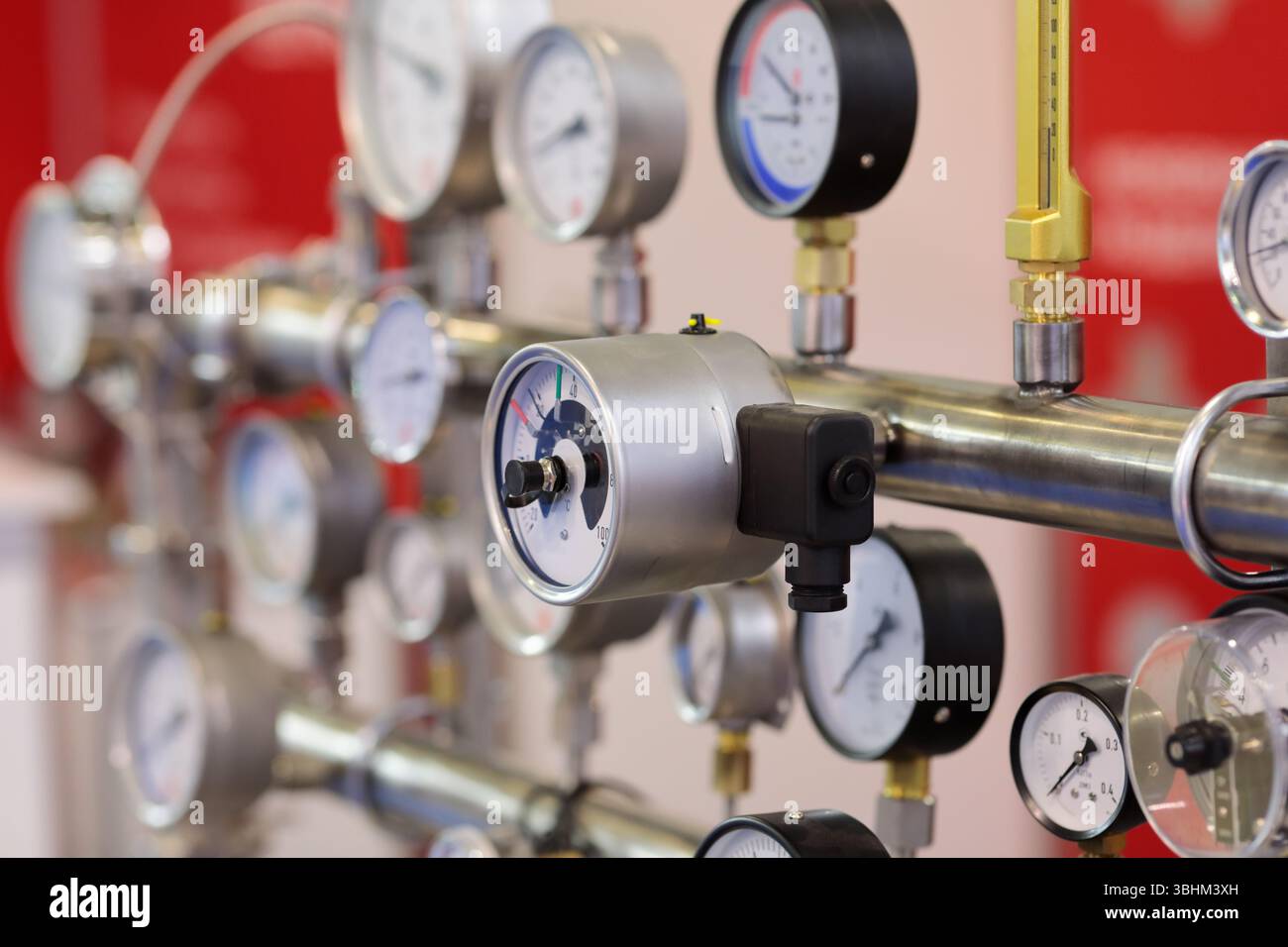 Pipes and various types of analog measuring gauges. Selective focus ...