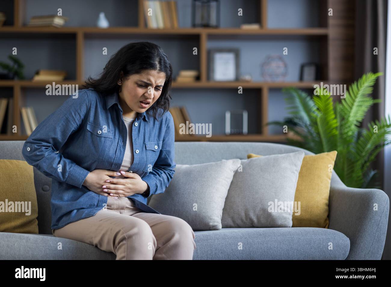 Woman clutches stomach holding hi-res stock photography and images - Alamy
