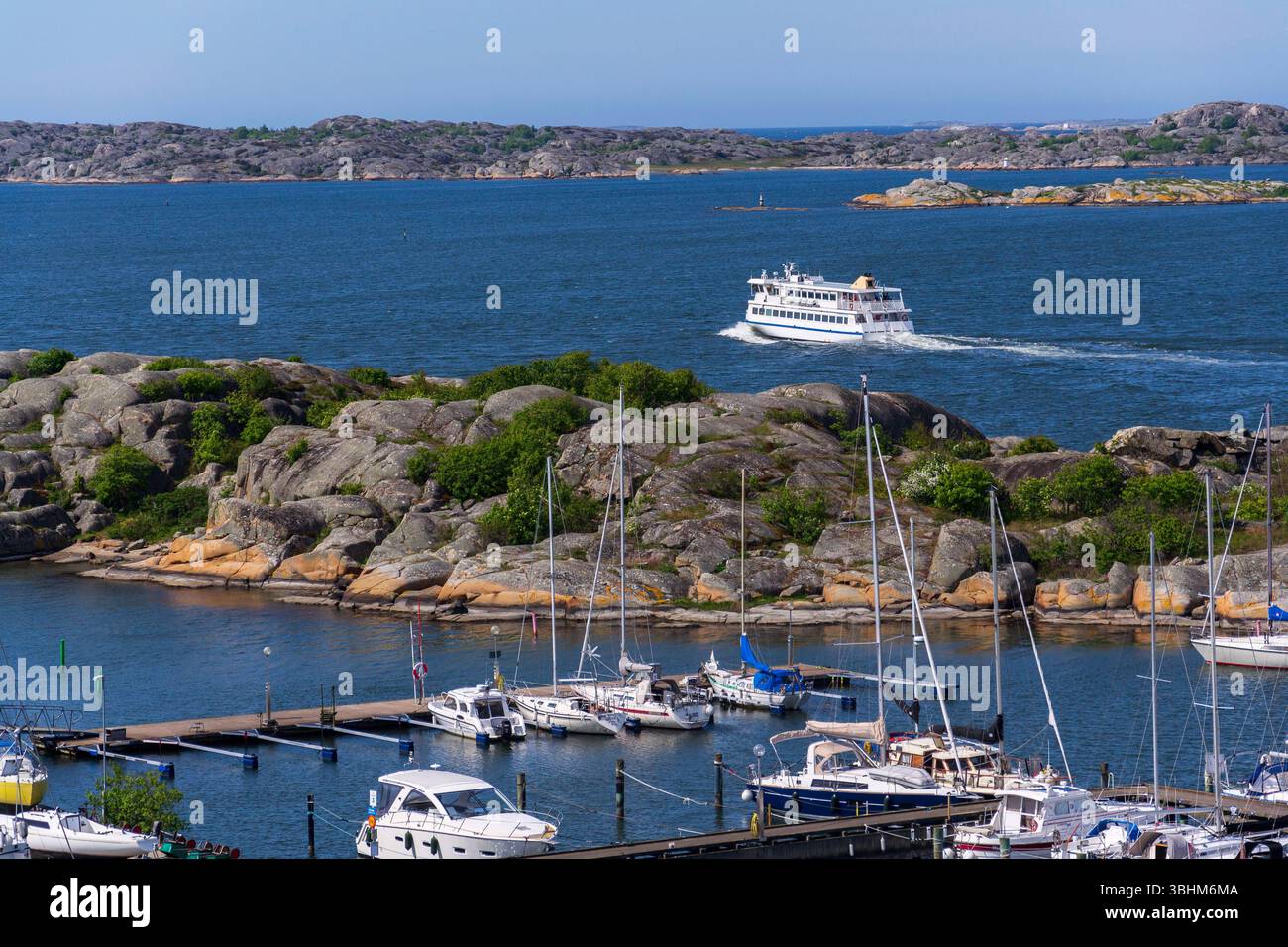 Archipelago ferry leaving harbour with ships at Saltholmen peninsula on ...