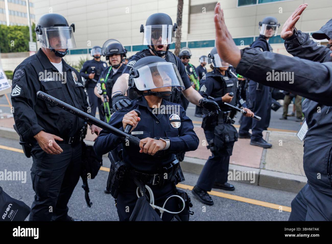 Los Angeles, USA. 09th June, 2025. LAPD Officer Cortez is restrained by ...