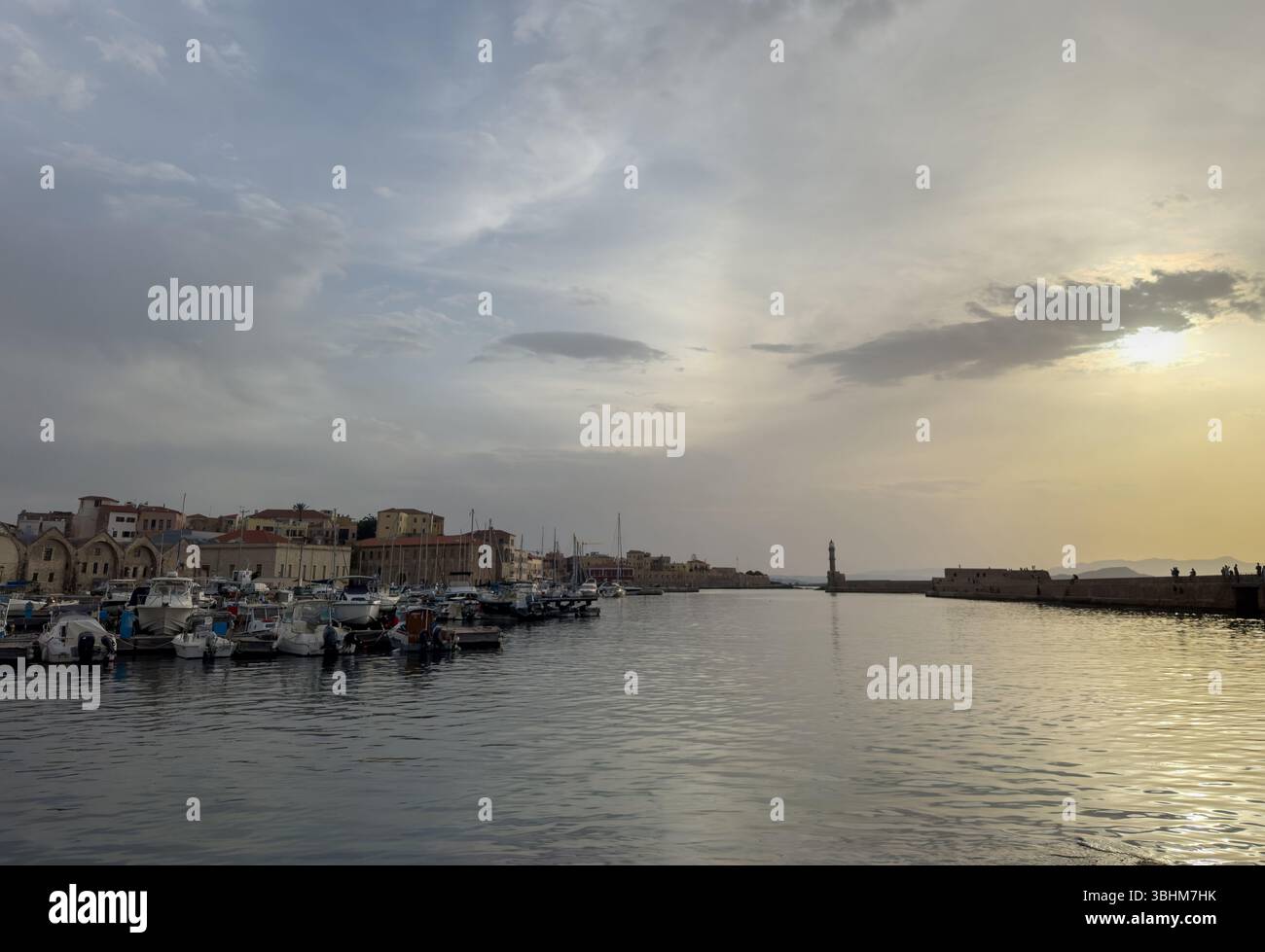 Crete, Chania old harbour. Waterfront buildings at sunset, old ...