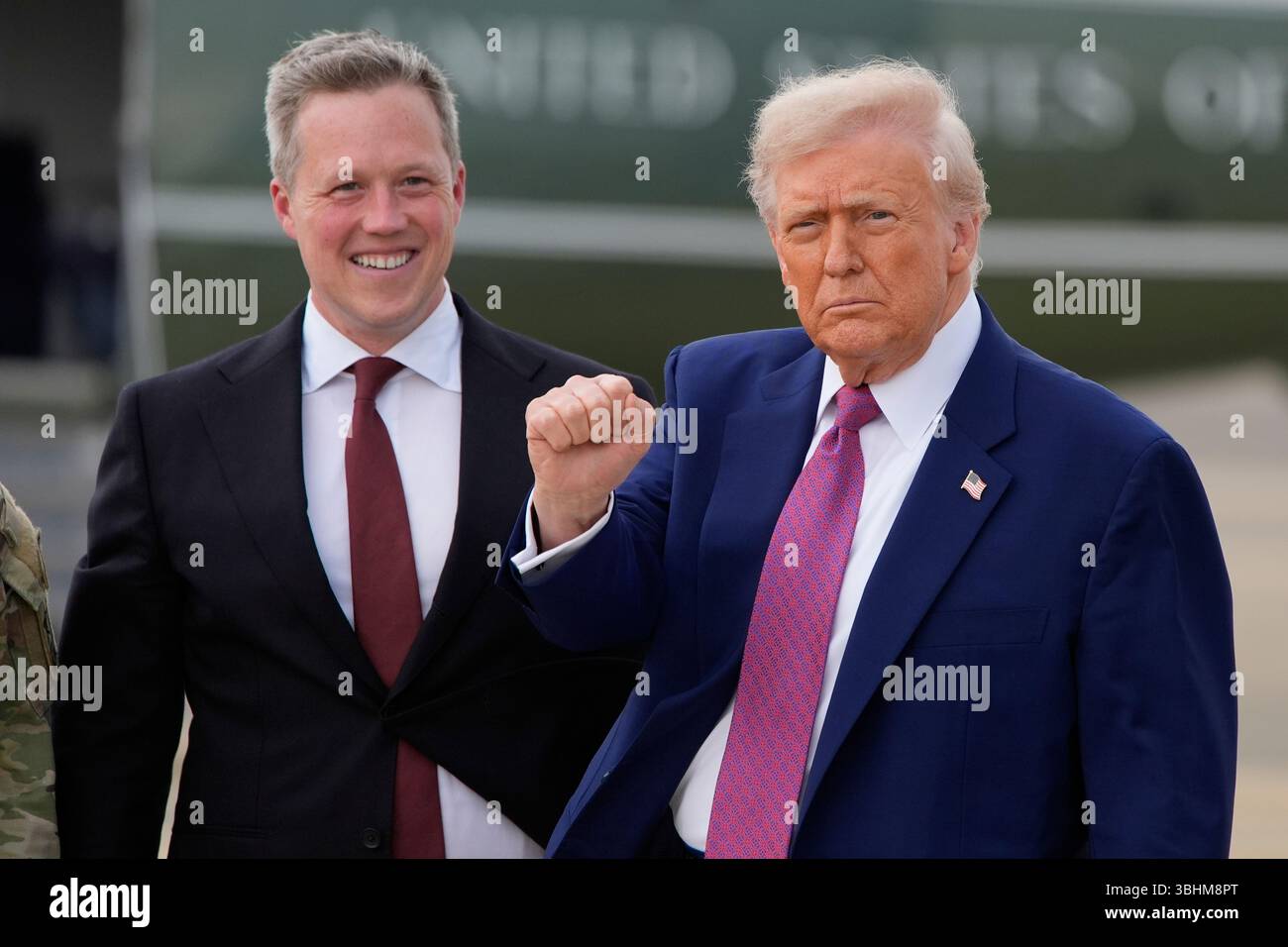 President Donald Trump gestures as Secretary of the U.S. Army Daniel Driscoll watches at Pope ...