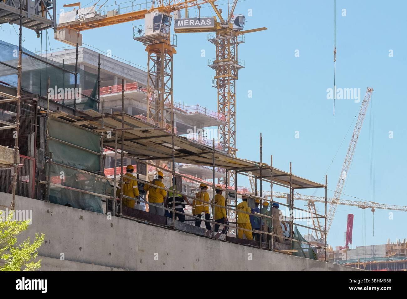 Group of construction workers wearing safety uniform gear while walking ...