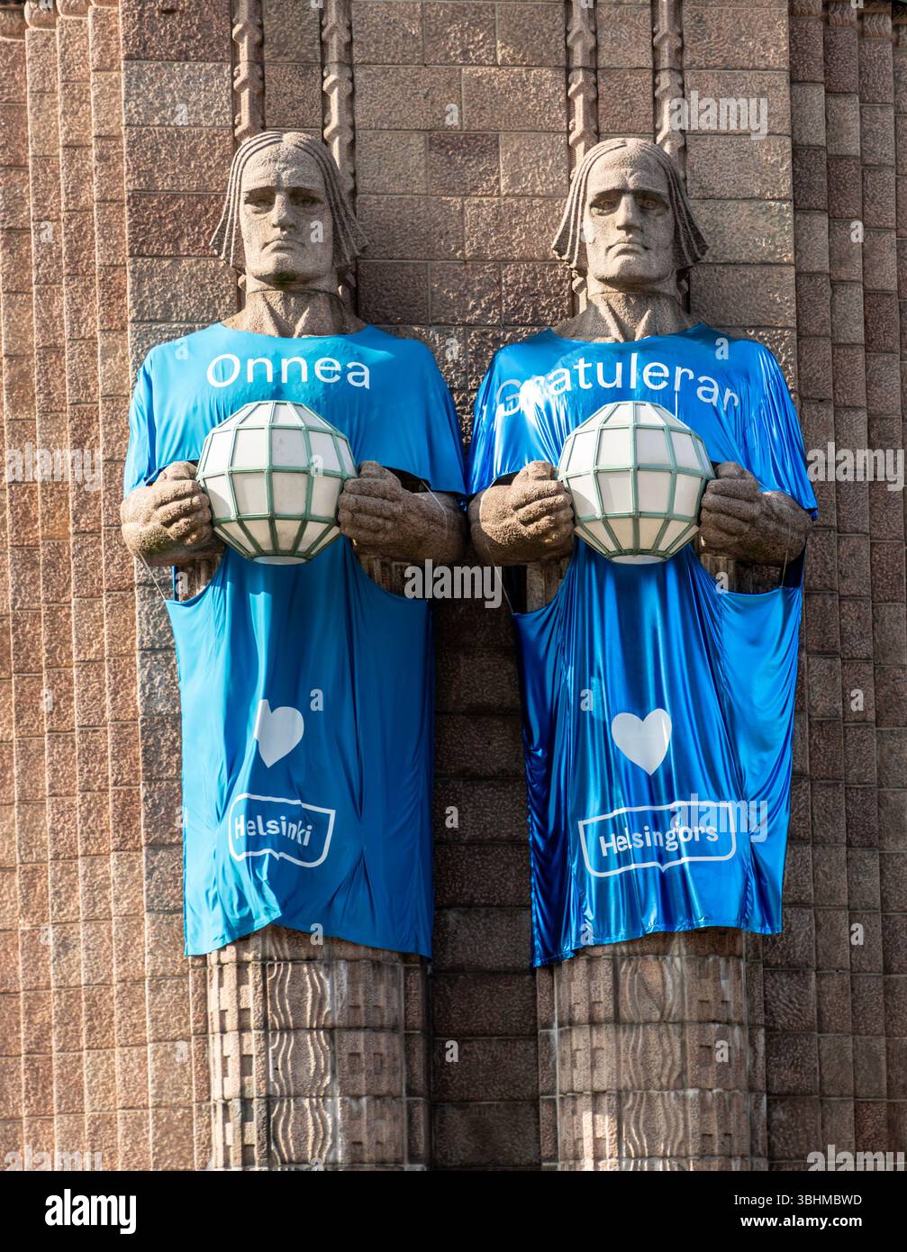 The Lyhdynkantajat sculptures at the Helsinki Central Station dressed ...