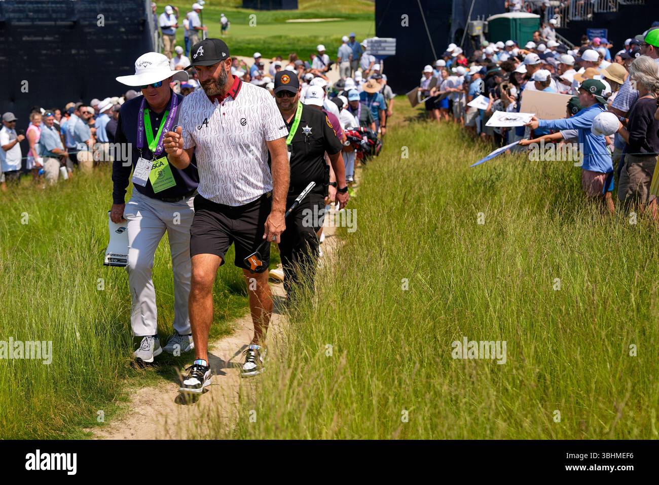 Dustin Johnson walks to the 14th tee during a practice round ahead of ...