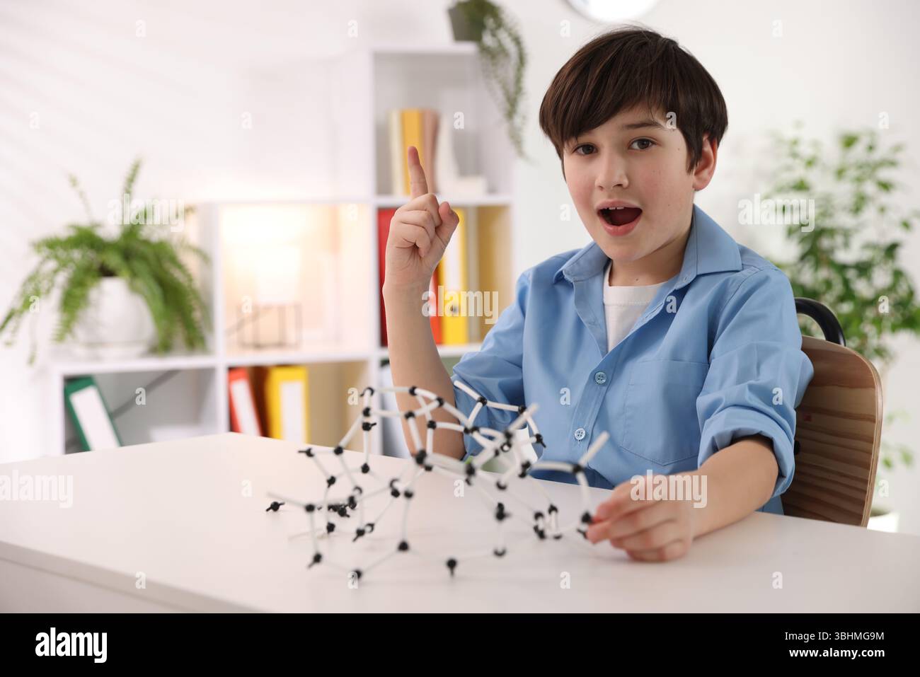Boy making DNA structure model at desk indoors. Space for text Stock ...