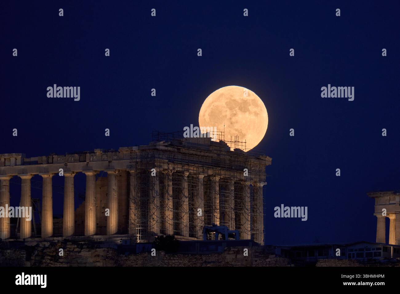 The strawberry moon rises in the sky behind the 5th century B.C ...