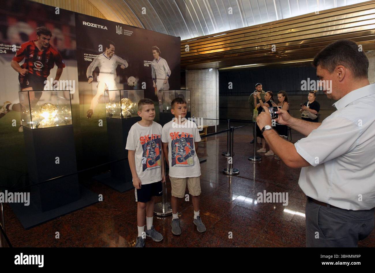 Two boys pose for a picture by the Ballon d’Or awards won by Ukrainian footballers (Oleh Blokhin ...