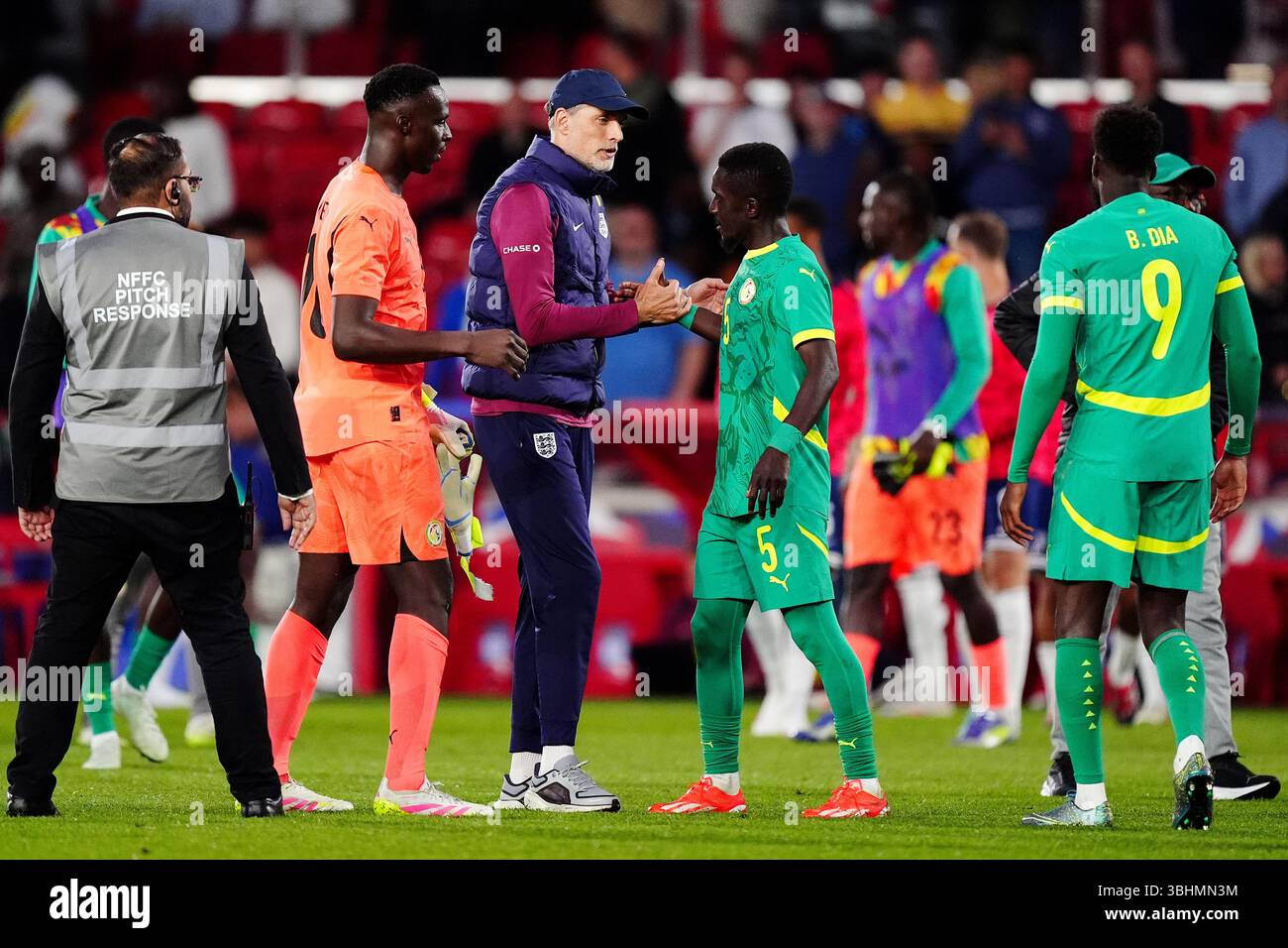 England manager Thomas Tuchel (centre left) and Senegal's Idrissa Gueye ...