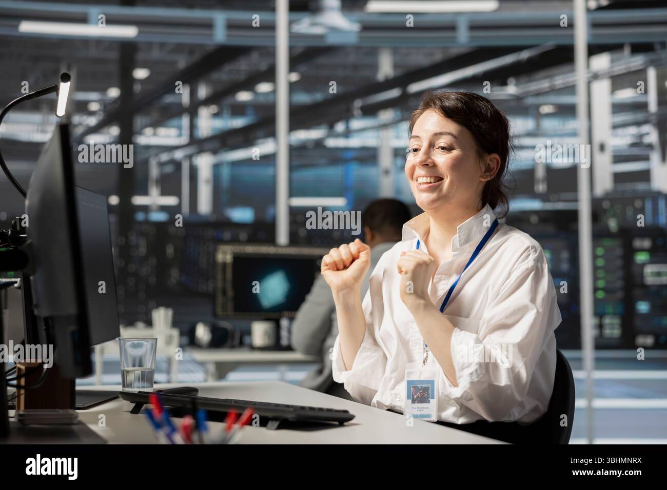 Joyous IT expert in data center office satisfied after checking report ...