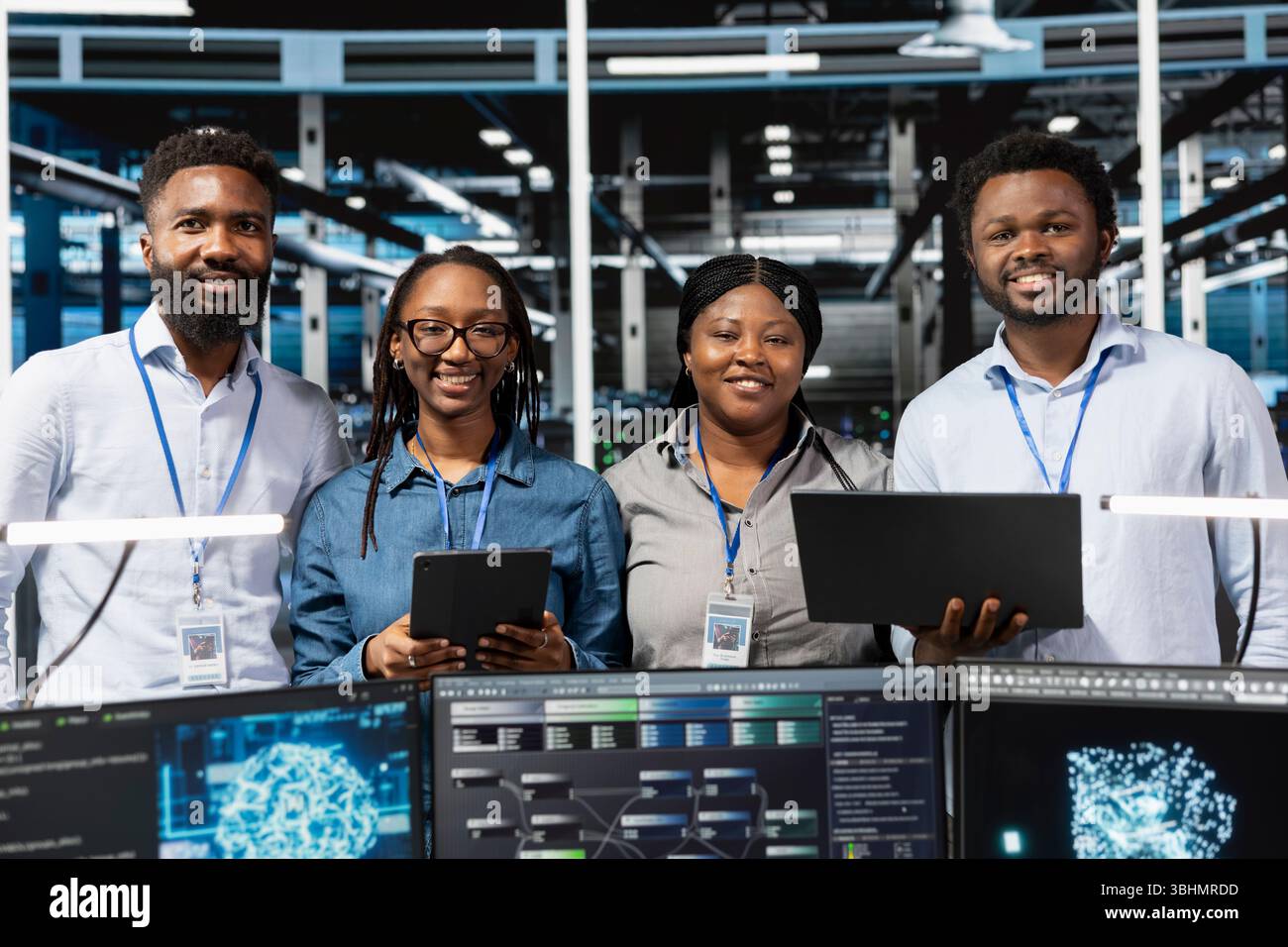 Portrait of happy server farm team looks at data analysis graph to reduce equipment failure ...
