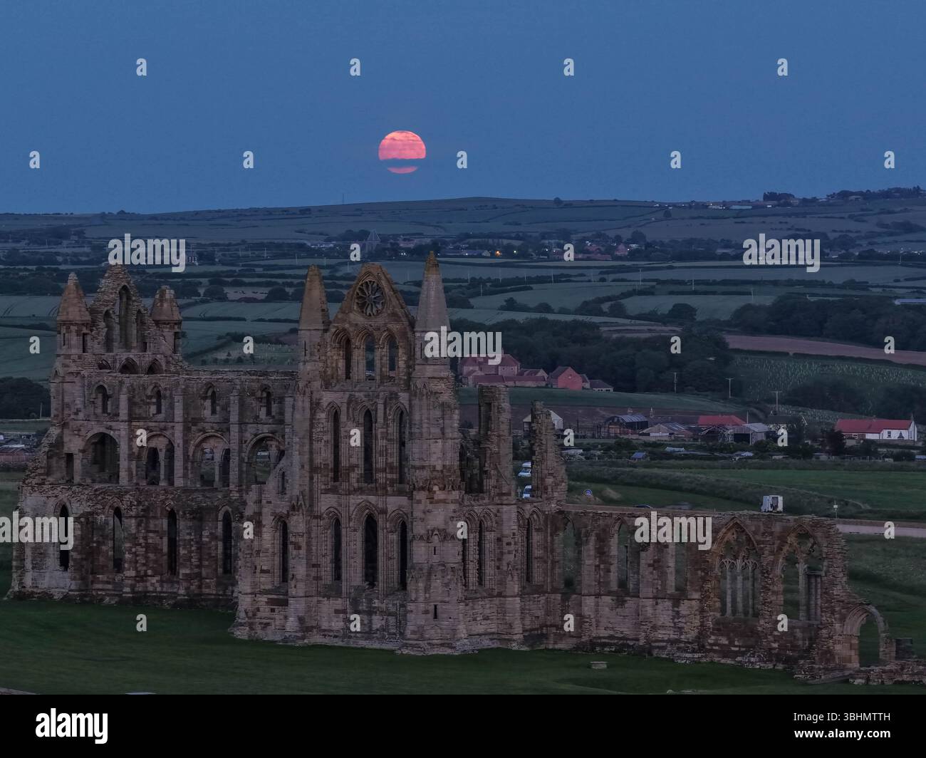 June’s rare Strawberry Moon rises over Whitby Abbey and Harbour, Whitby ...